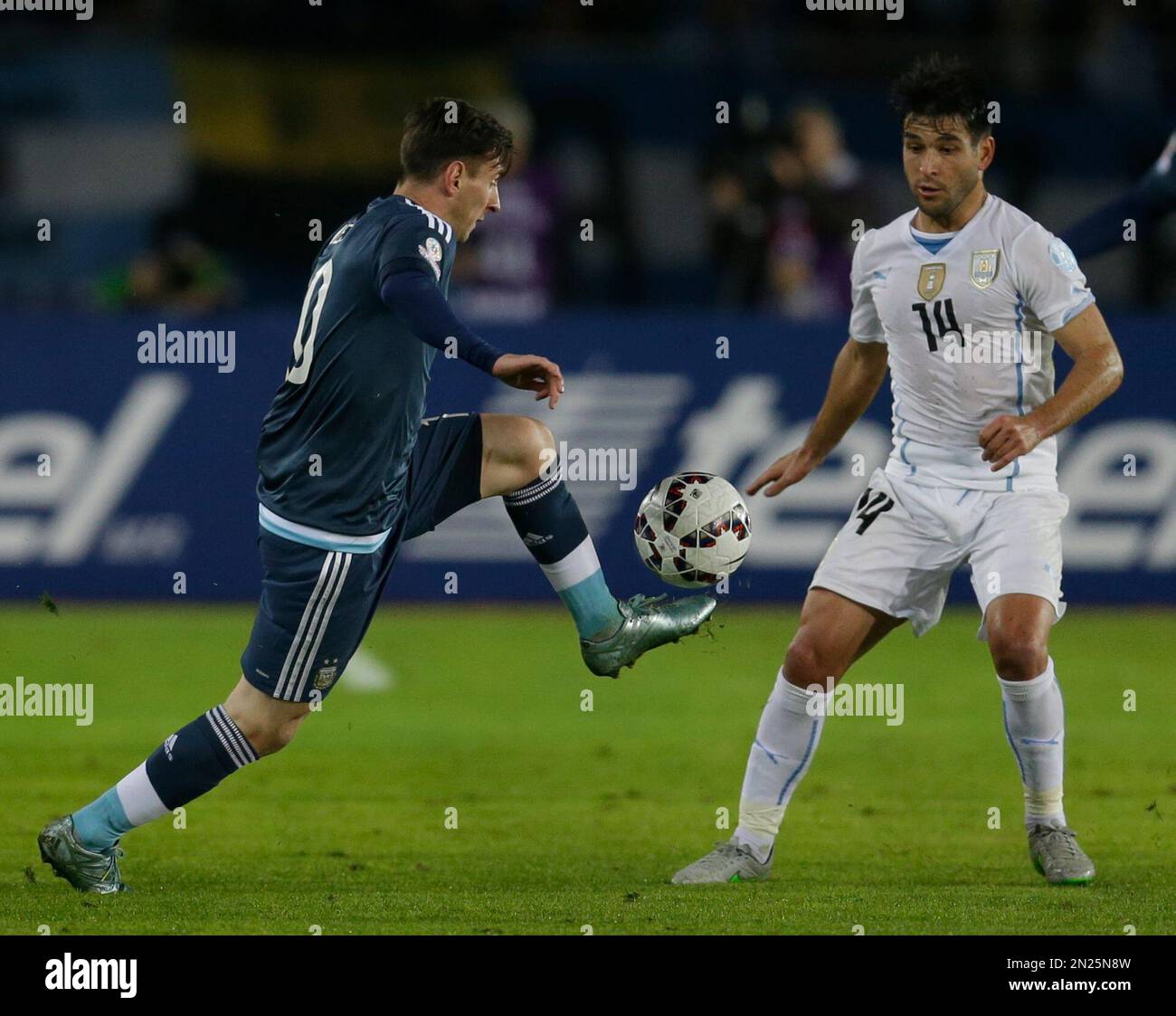 Argentina's Lionel Messi, left, controls a ball under the pressure of ...