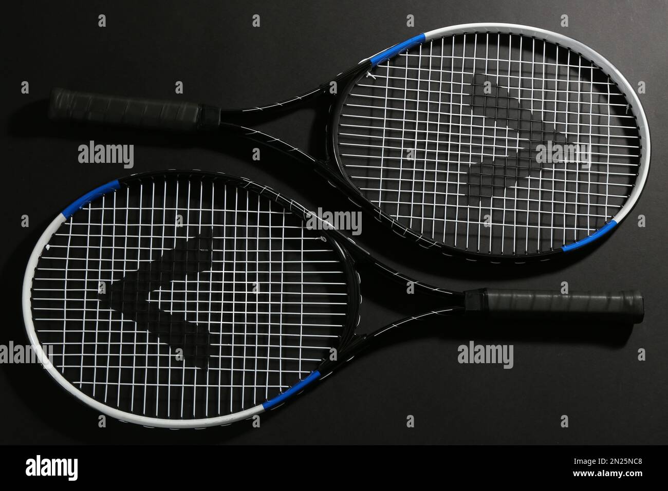 Tennis rackets on black background, flat lay. Sports equipment Stock ...