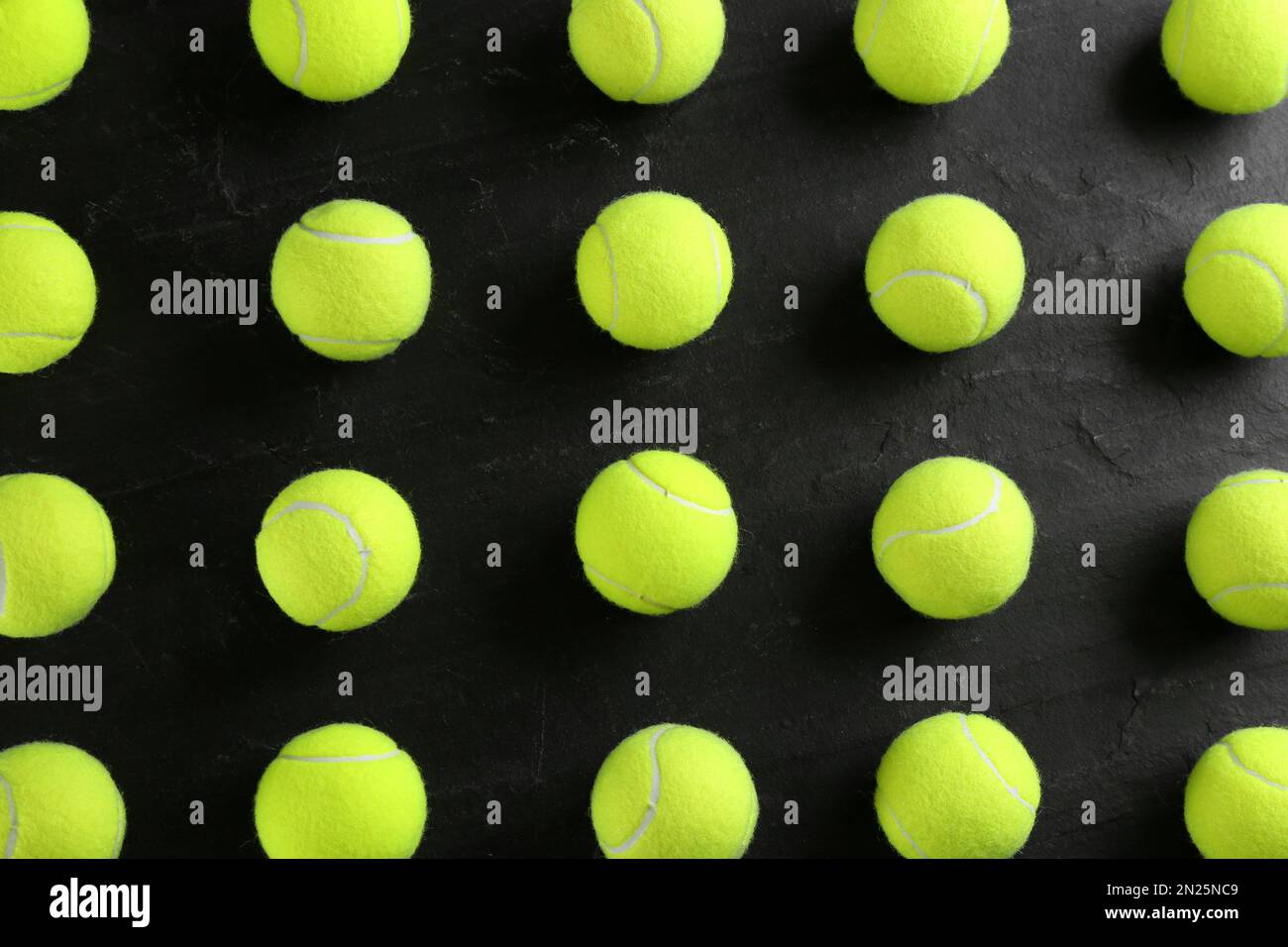 Tennis balls on black background, flat lay. Sports equipment Stock ...