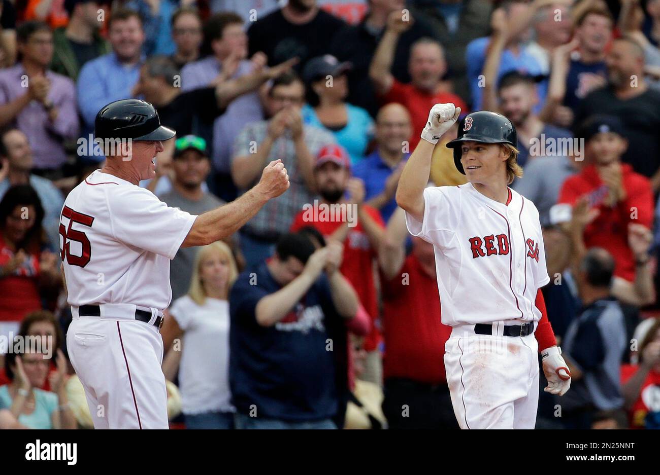 Boston Red Sox third base coach Brian Butterfield, left, fist bumps ...