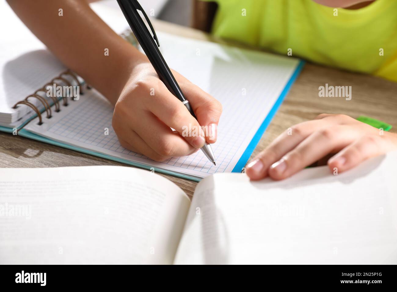 Preteen girl doing homework at table, closeup Stock Photo - Alamy