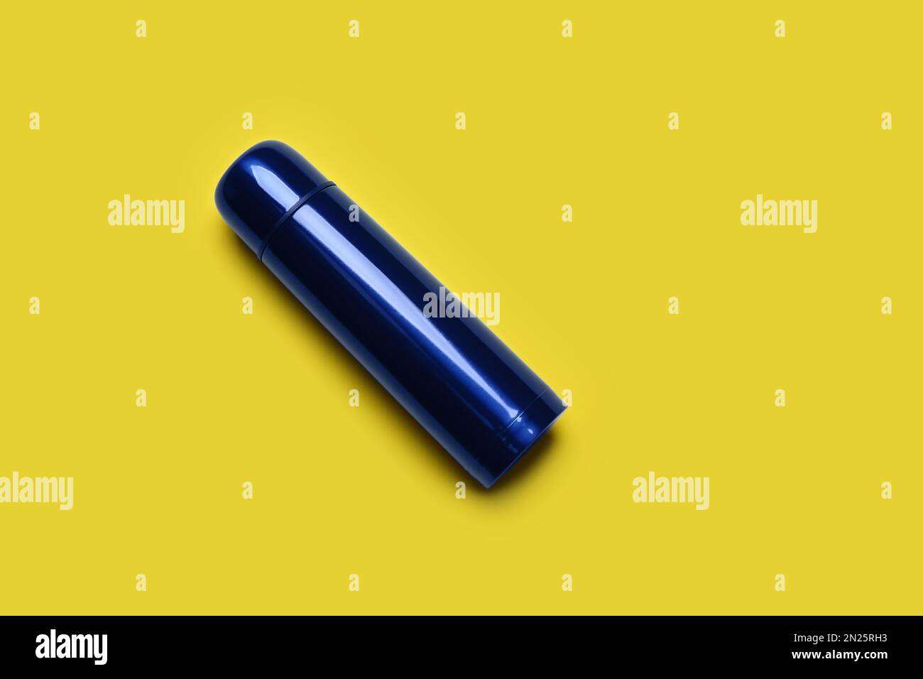 Blue metal thermos on yellow background, top view. Space for text Stock ...
