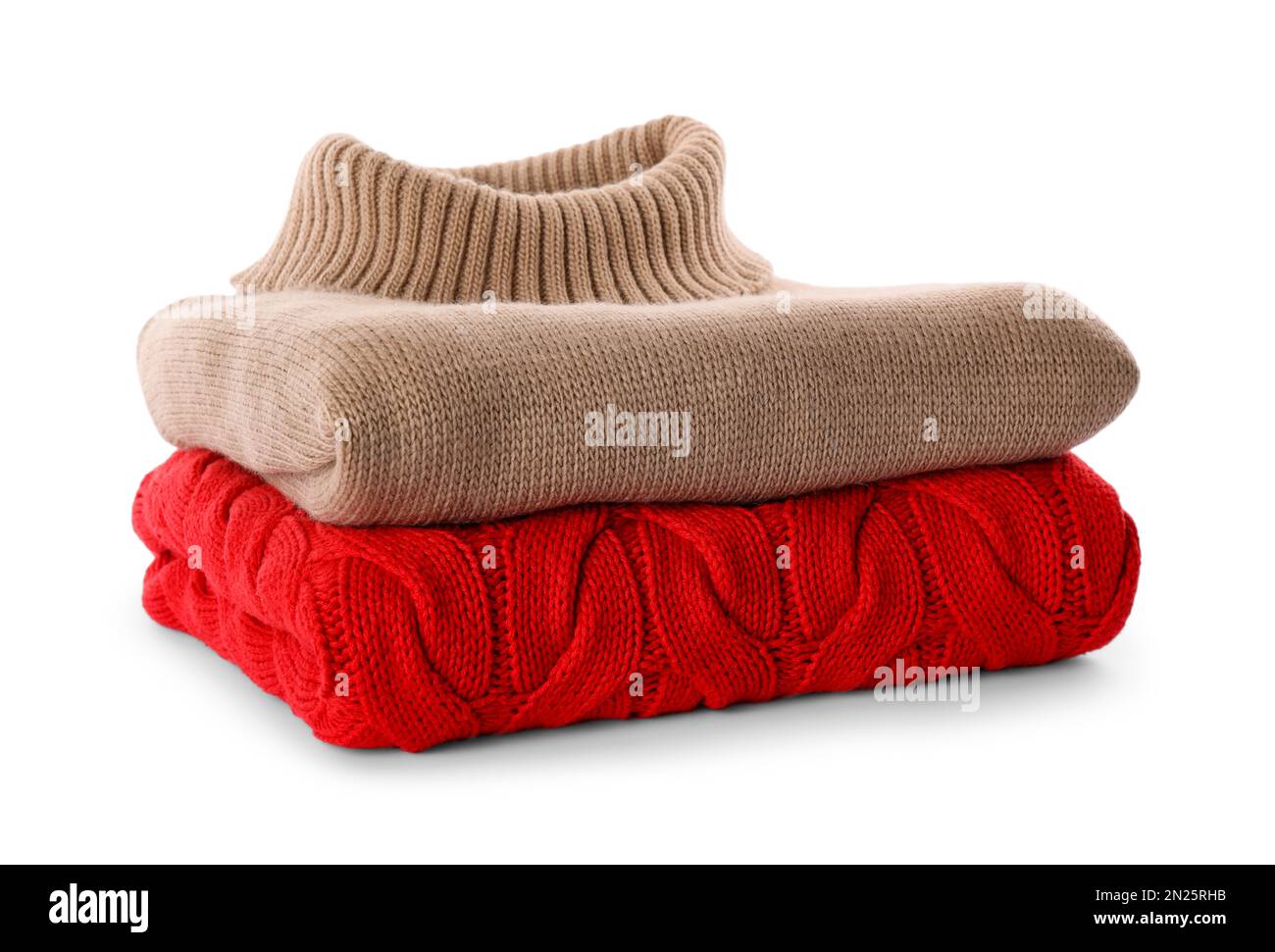 Stack of different warm sweaters isolated on white Stock Photo - Alamy