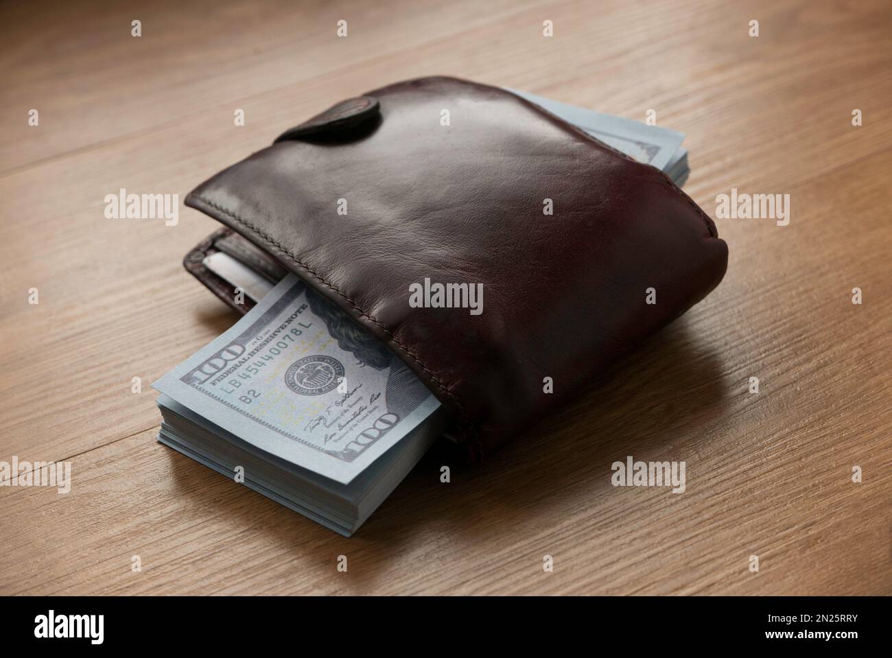 Selective focus of a money inside a wallet on wooden background Stock ...