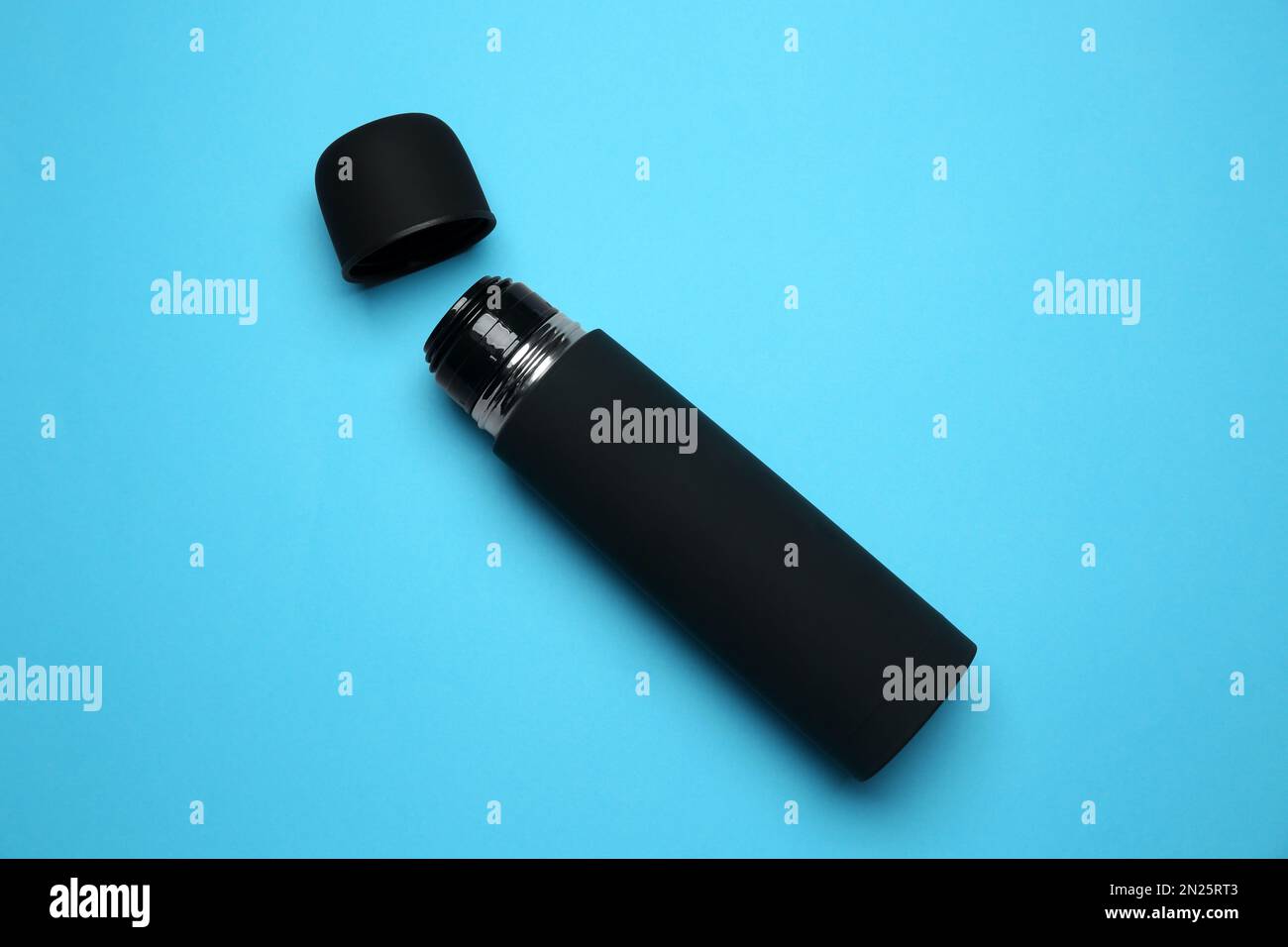 Black thermos on light blue background, top view Stock Photo - Alamy