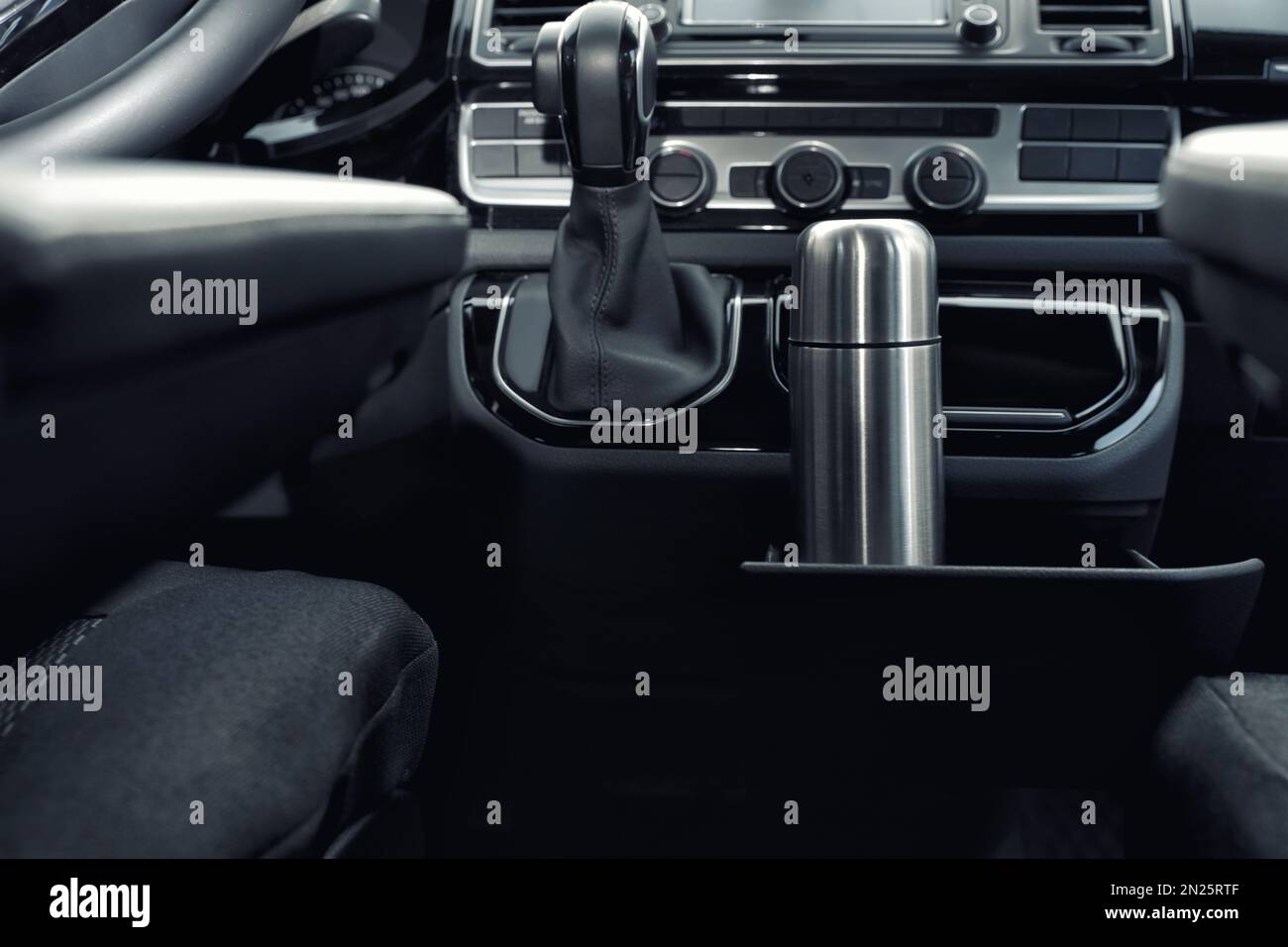 Silver thermos in holder inside of car Stock Photo - Alamy