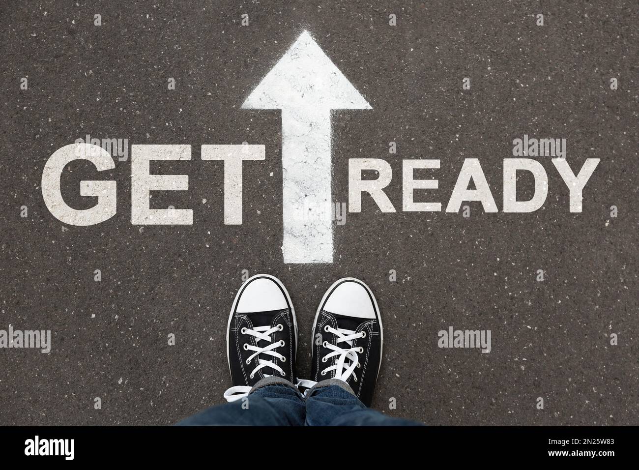 Text Get Ready and arrow on asphalt in front of woman, top view Stock ...