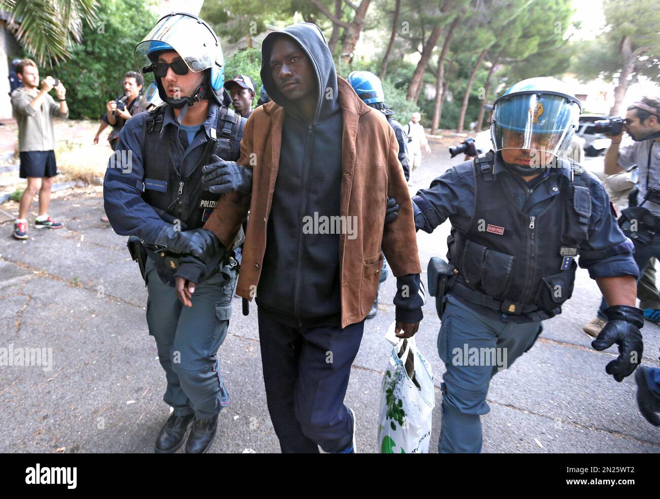 A migrant is evacuated by Italian police at the Franco-Italian border ...