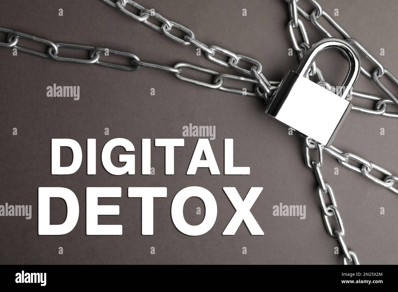 Digital detox concept. Steel padlock, chains and text on grey ...