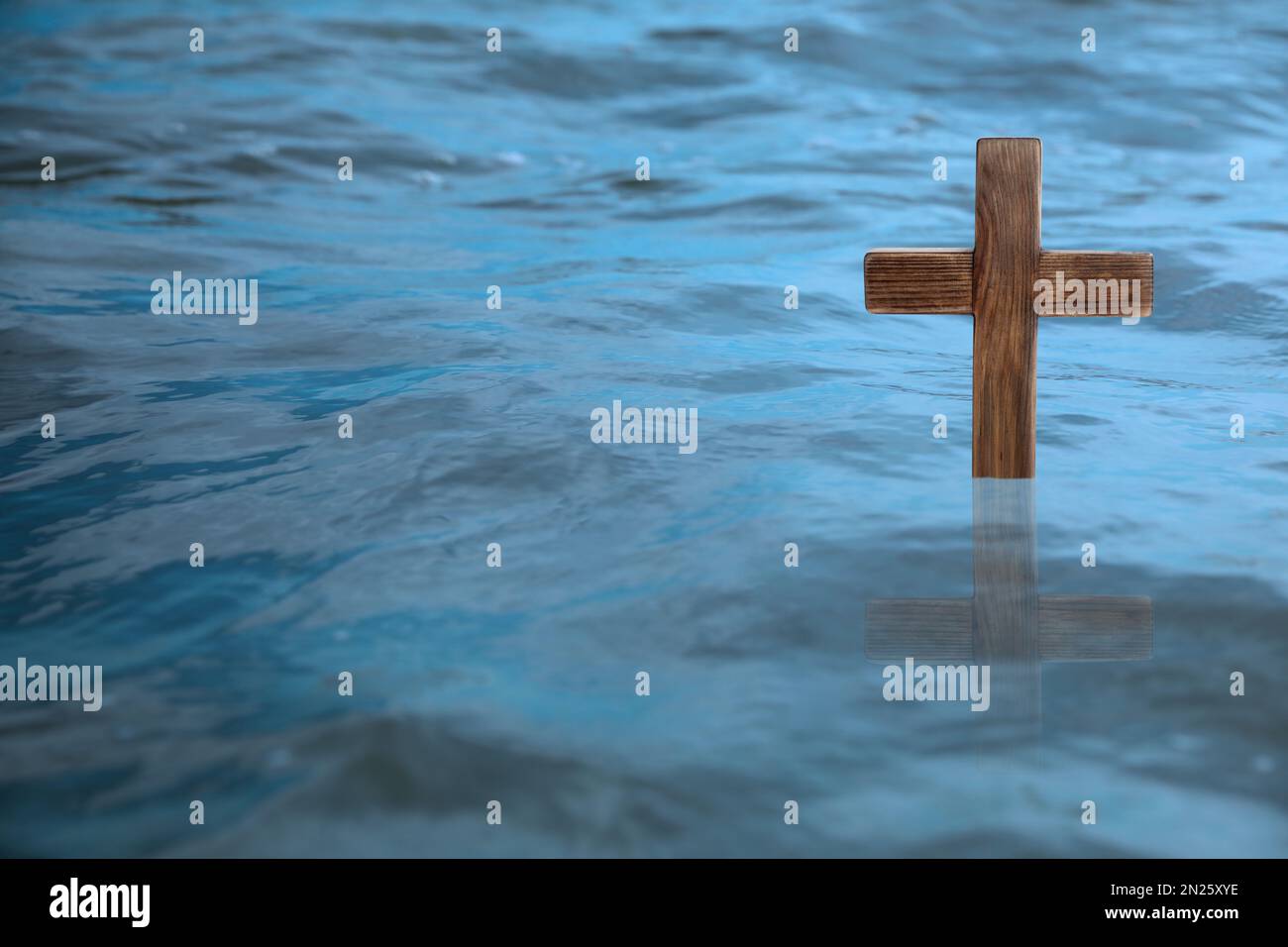 Wooden cross in river for religious ritual known as baptism Stock Photo ...