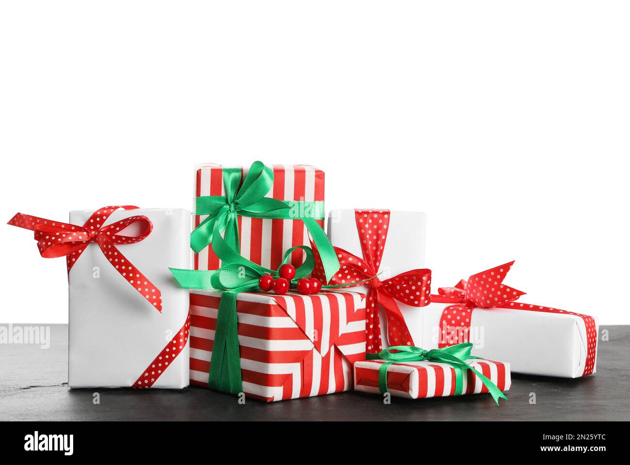 Many different Christmas gifts on table against white background Stock ...