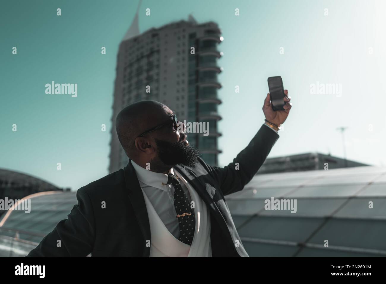 A portrait of a black, unshaven, and bald male, looking dapper in his ...