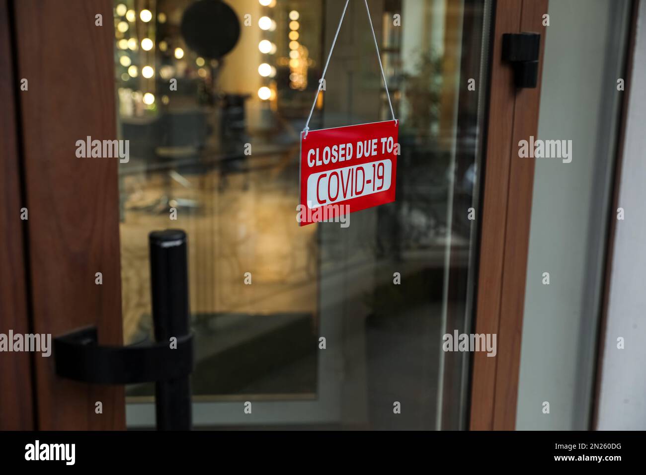 Red sign with words Closed Due To Covid-19 hanging on glass door Stock ...