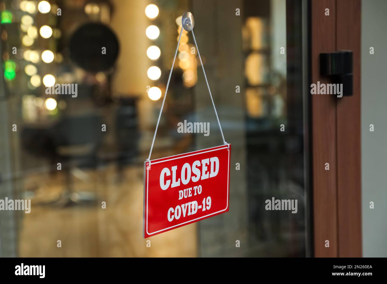 Red sign with words Closed Due To Covid-19 hanging on glass door Stock ...