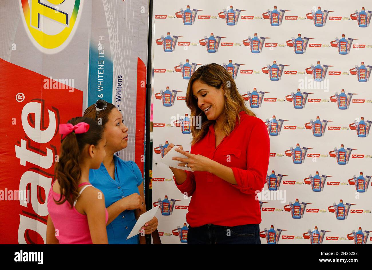 Karla Martinez, right, signs autographs for fans as part of Colgate's ...