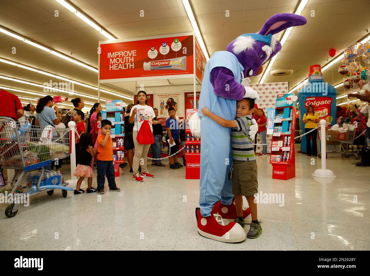 The Colgate Bright Smiles Bright Futures mascot Dr. Rabbit hugs a child ...