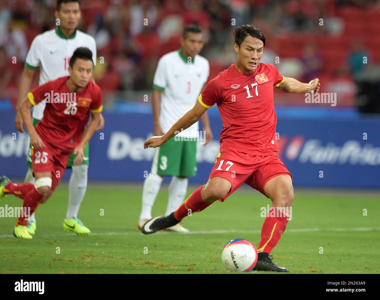 Mac Hong Quan of Vietnam, right, takes a successful penalty shot ...