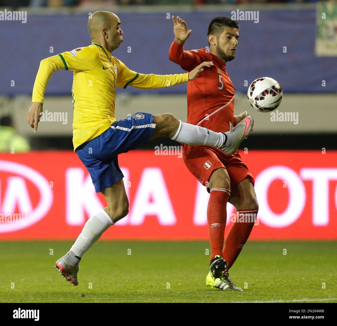 Brazil's Diego Tardelli, left, and Peru's Carlos Zambrano vie for the ...