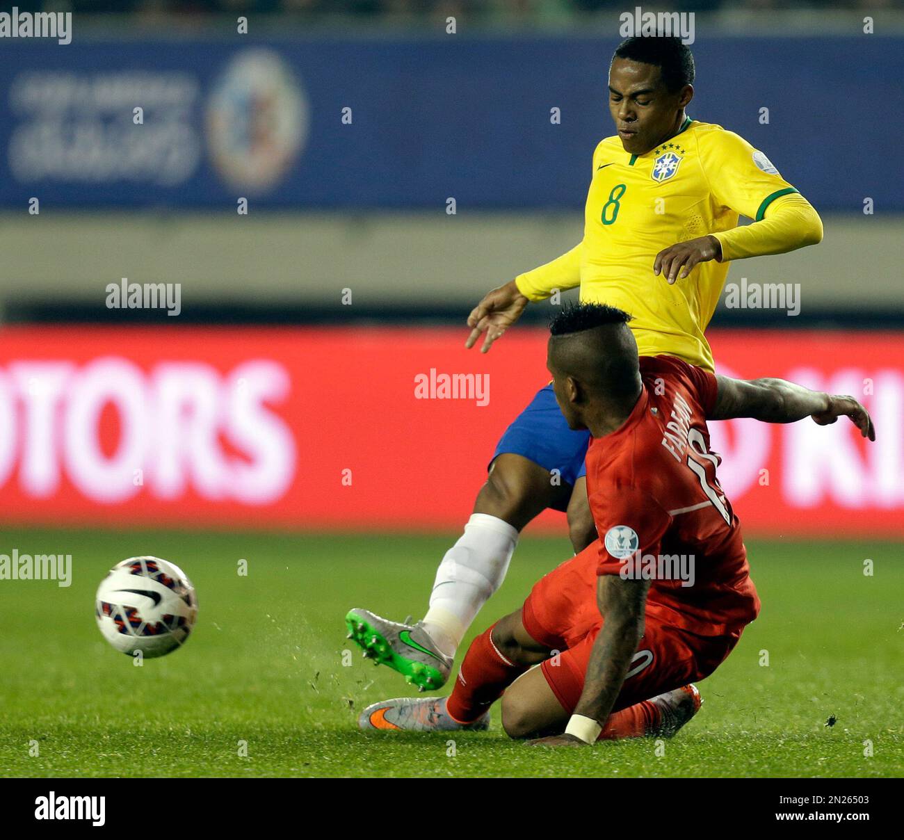 Brazil's Elias, top, and Peru's Jefferson Farfan fight for the ball ...