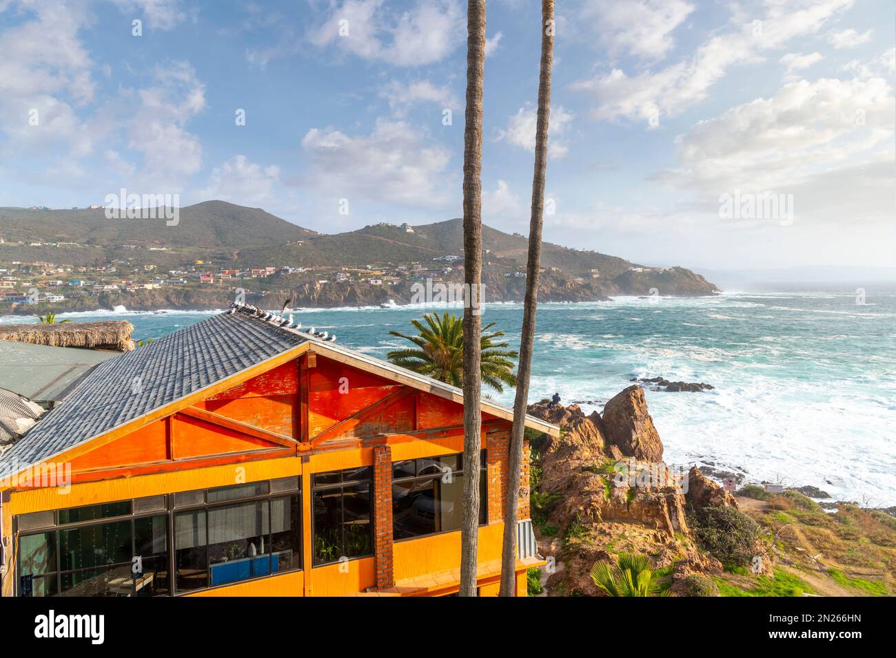A colorful Mexican cafe overlooks the rocky coastline along the Pacific ...