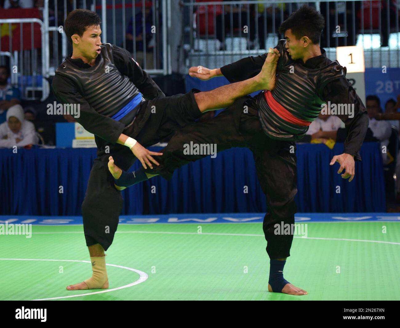 Pornteb Poolkaew of Thailand, left, and Muhammad Fahmi Romli of Malaysia, exchange kicks during ...