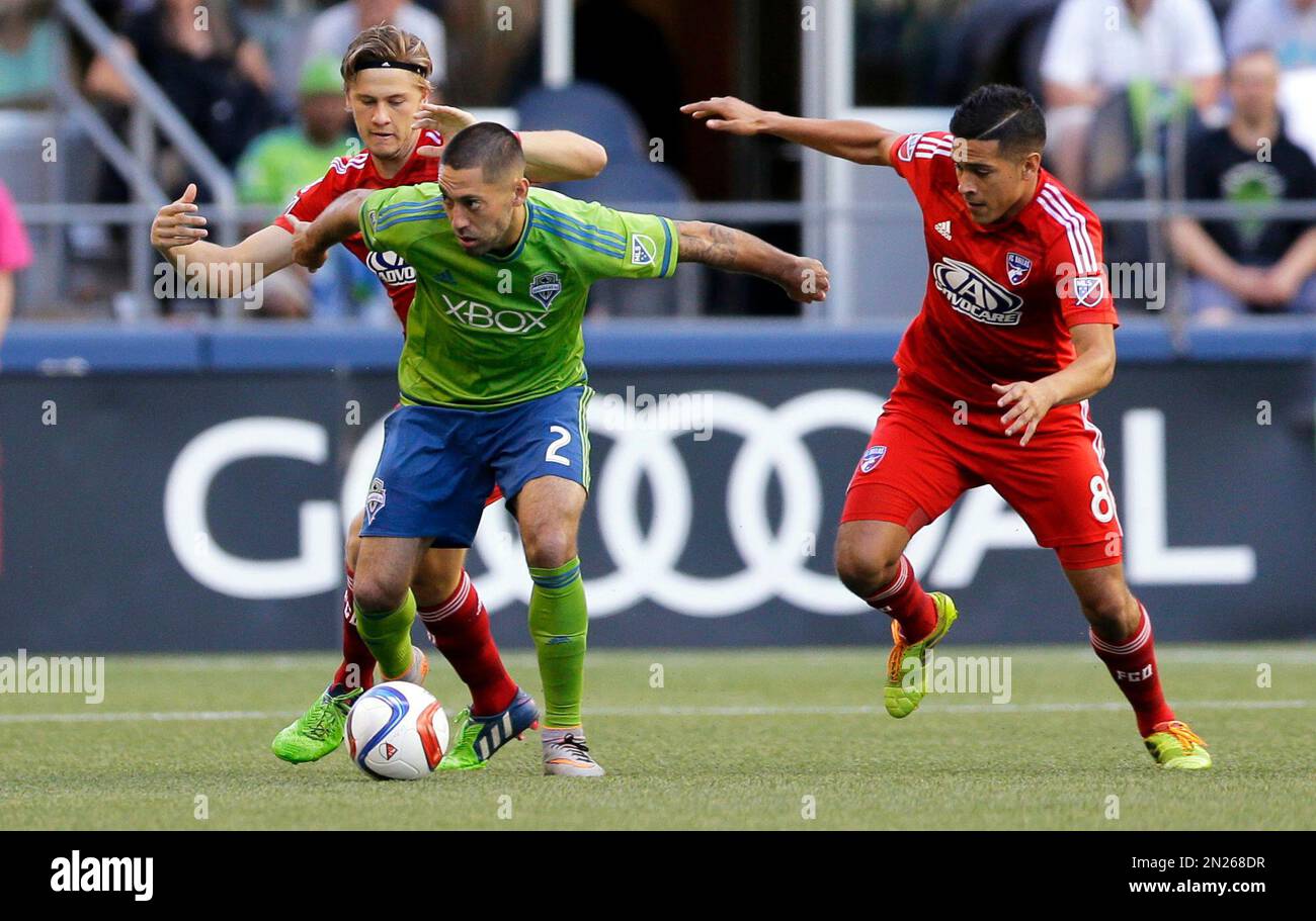 Seattle Sounders' Clint Dempsey (2) tries to hold off FC Dallas' Walker ...