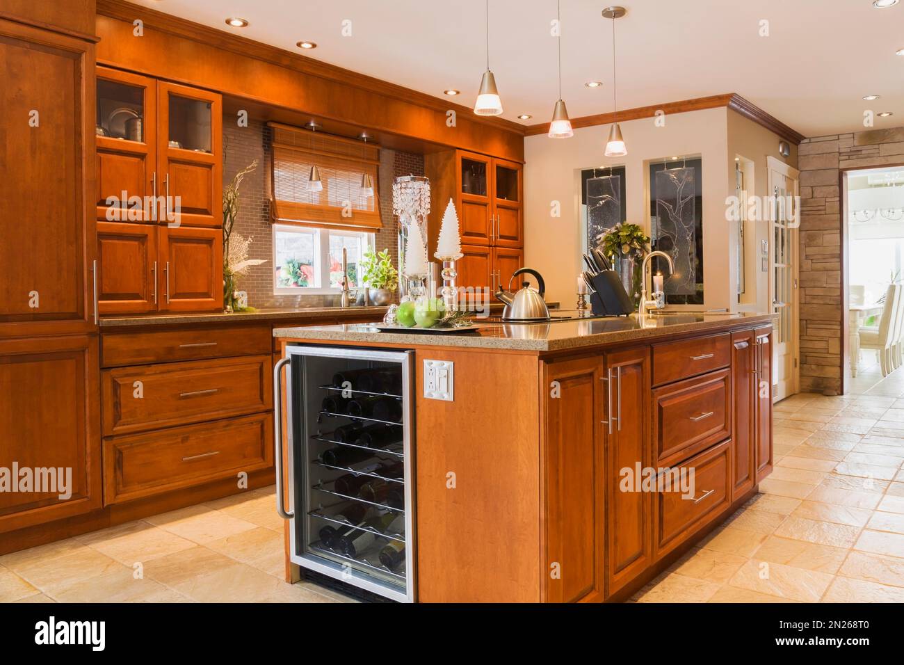 Cherry wood cabinets and island with quartz countertops in kitchen ...