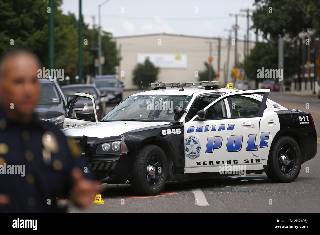 Deputy Chief of Police Gilberto Garza walks by a cruiser with bullet ...