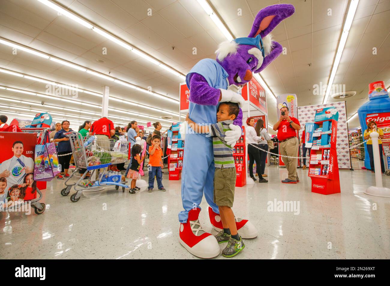IMAGE DISTRIBUTED FOR COLGATE - A child embraces a giant purple bunny ...
