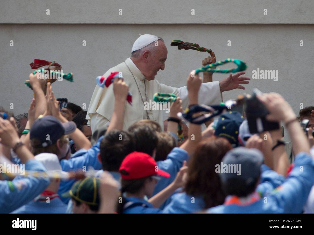 Pope Francis is cheered by the crowd as he arrives for an audience with ...