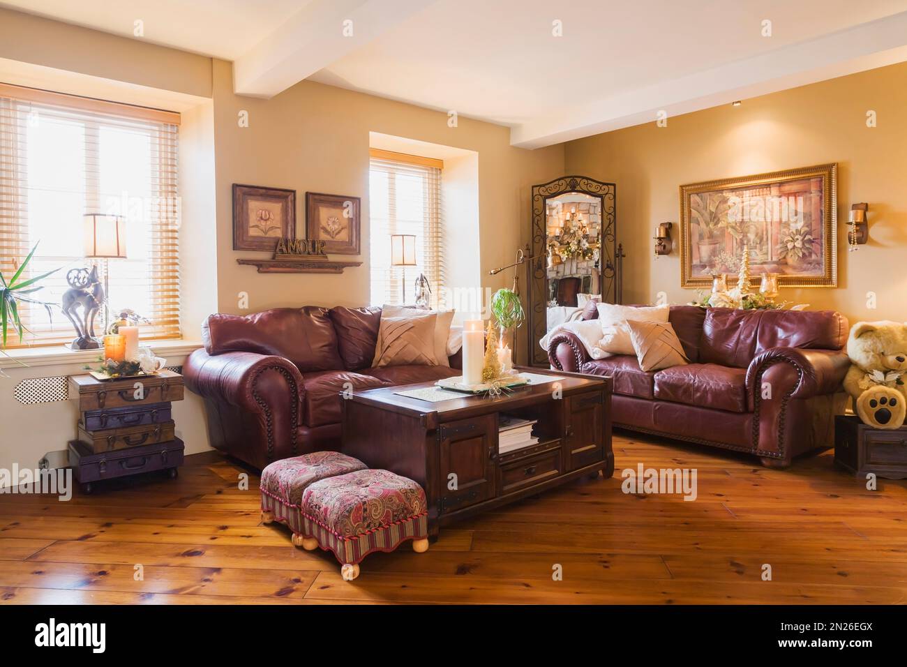 Burgundy leather sofas and wooden coffee table in living room inside ...