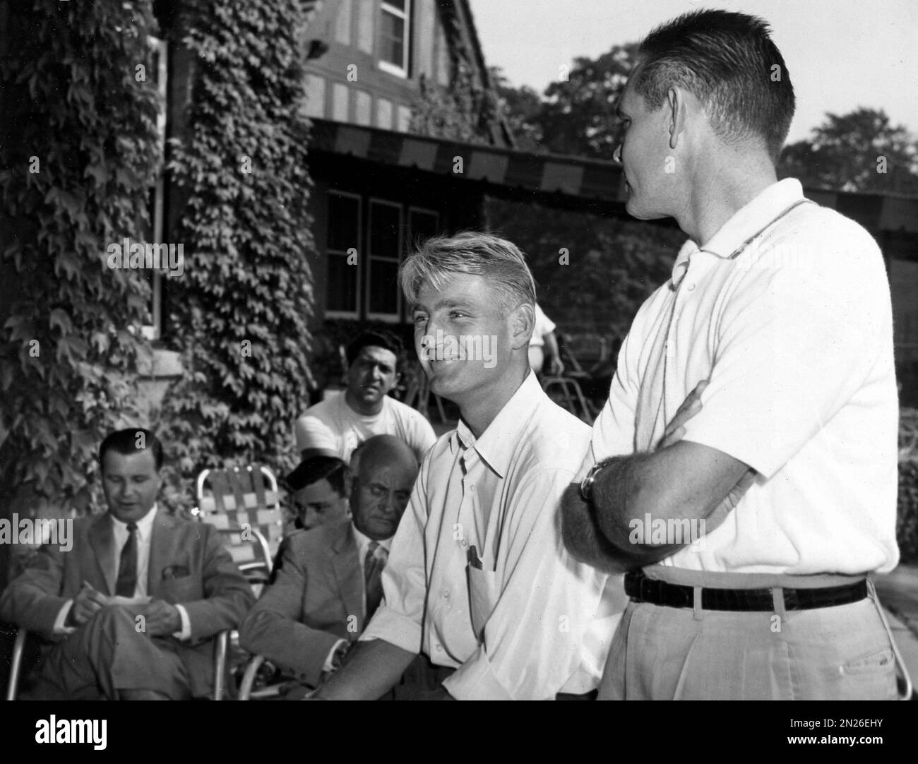 Australian tennis star Lew Hoad, center, smiles as he discusses signing ...