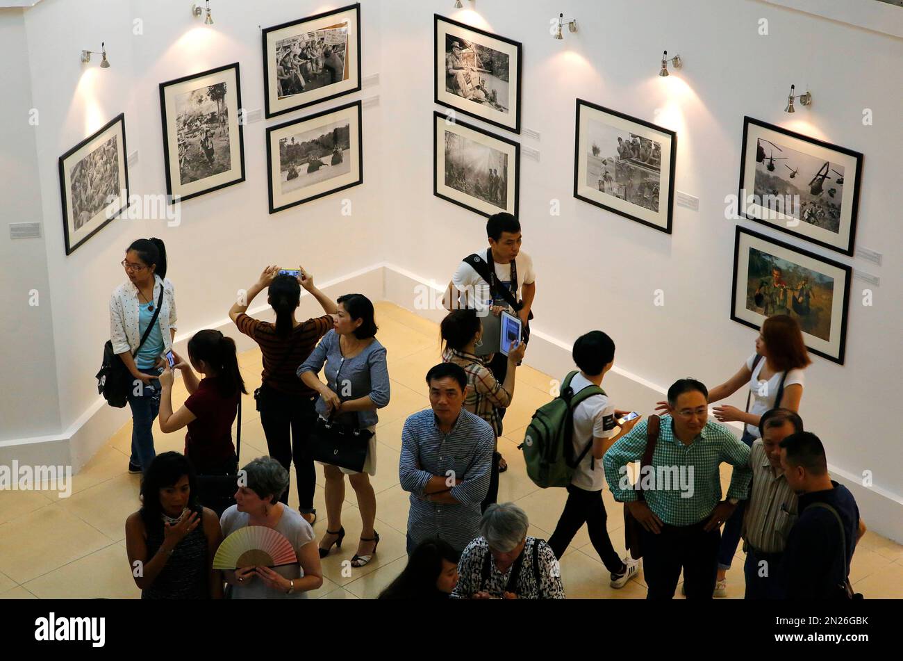 Guests and members of the public view photos from the Vietnam War on ...