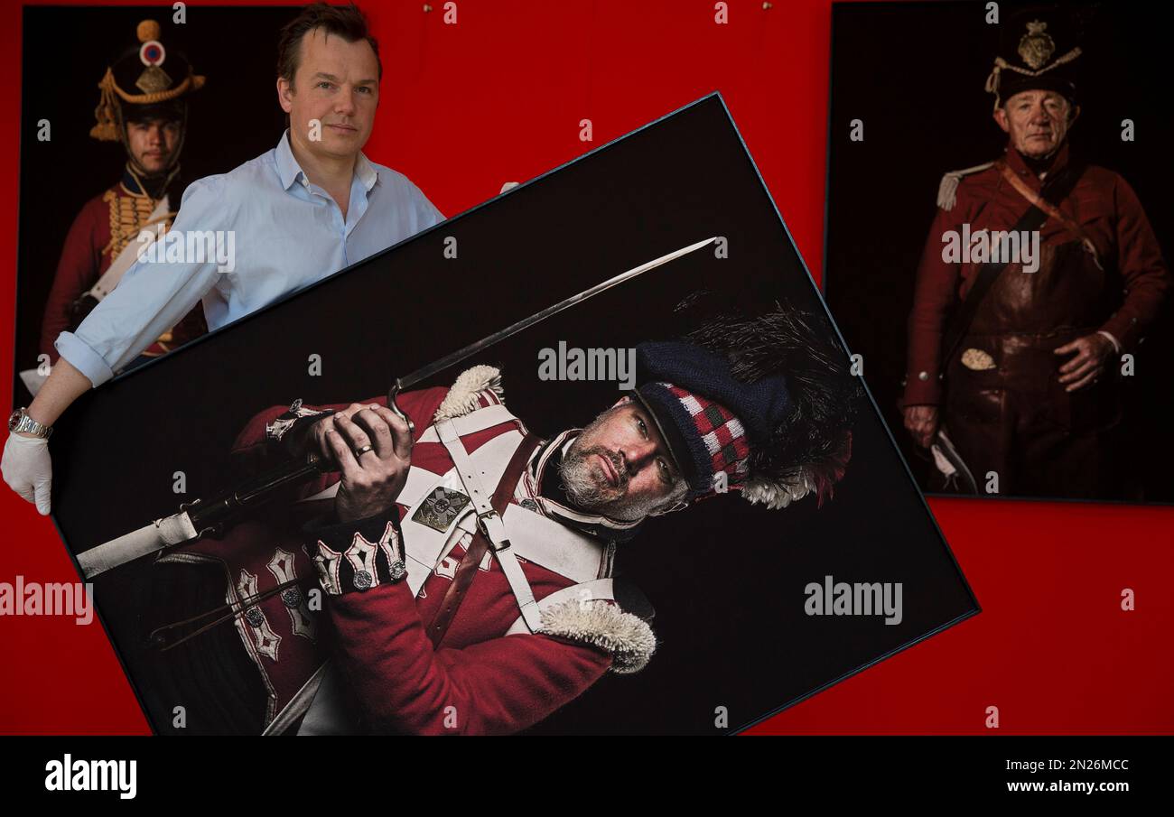 British photographer Sam Faulkner, poses with a photographic portrait ...