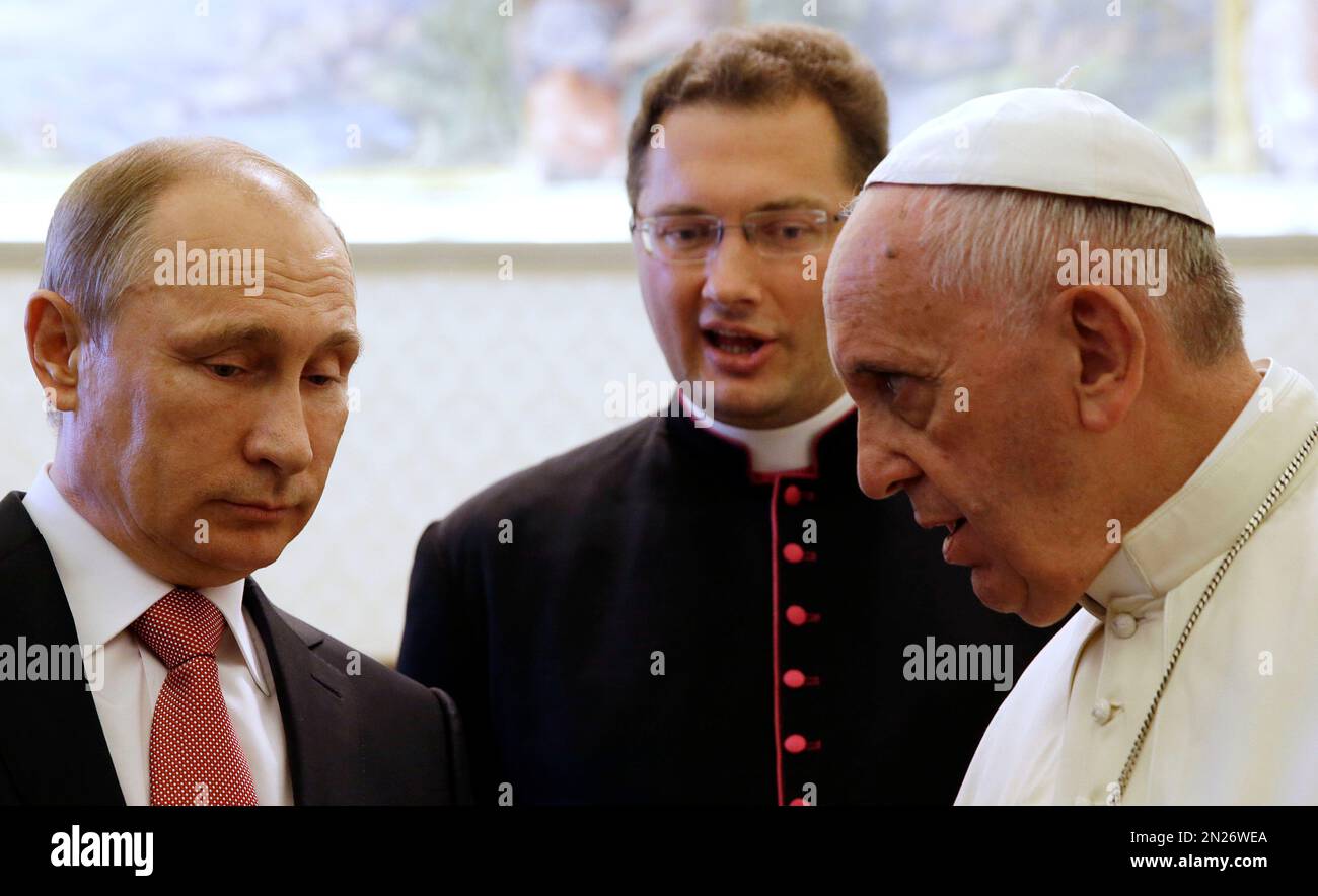 Russian President Vladimir Putin listens to Pope Francis on the ...