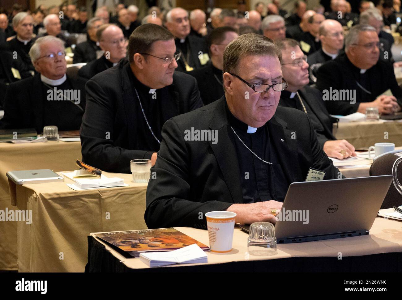 Rev. James William Tobin, Archbishop of Indianapolis, takes notes ...