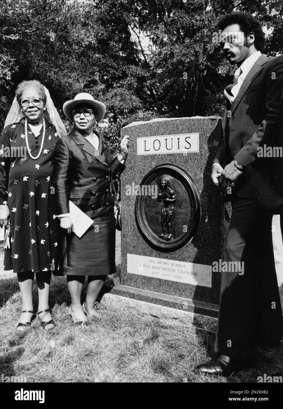The Rev. Jesse Jackson stands with Martha Malone Louis, center, the ...