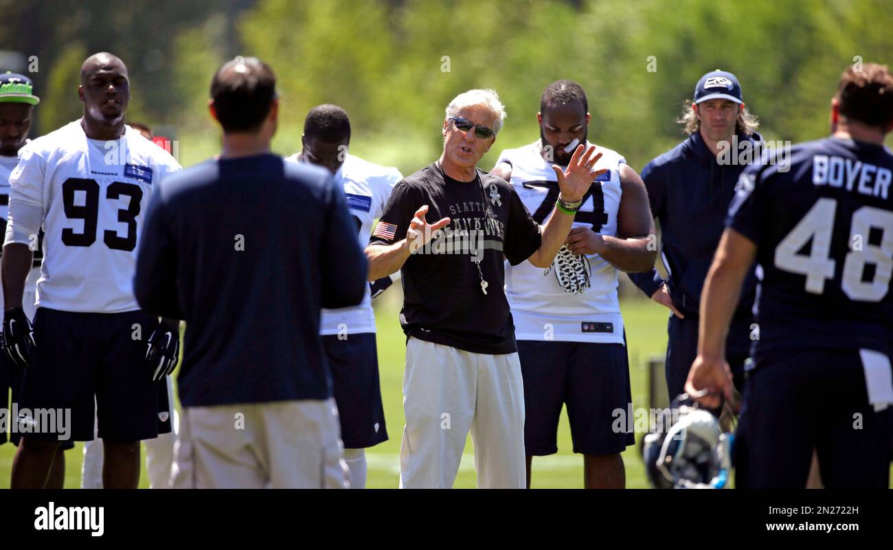 Seattle Seahawks head coach Pete Carroll talks with players and coaches ...