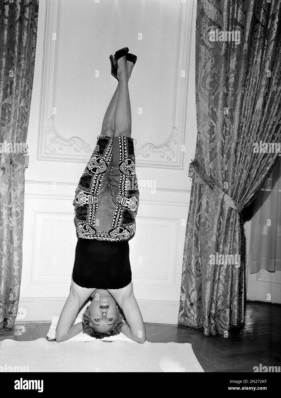 Film star Gloria Swanson is pictured in a yoga pose, her routine to ...