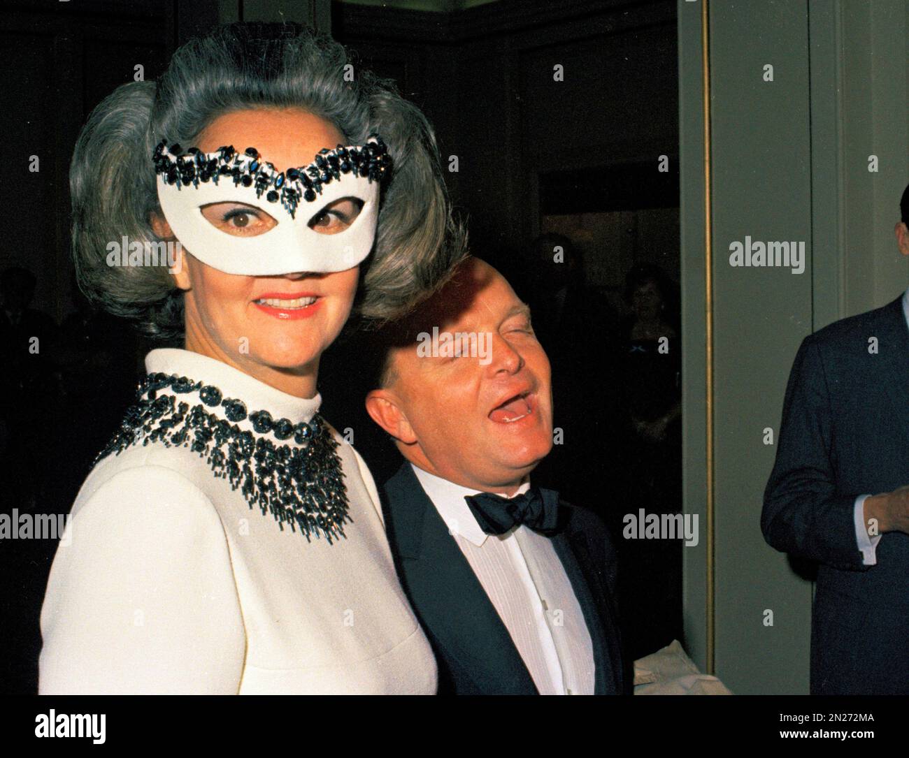Washington Post publisher Katharine Graham, wearing mask, attends the ...