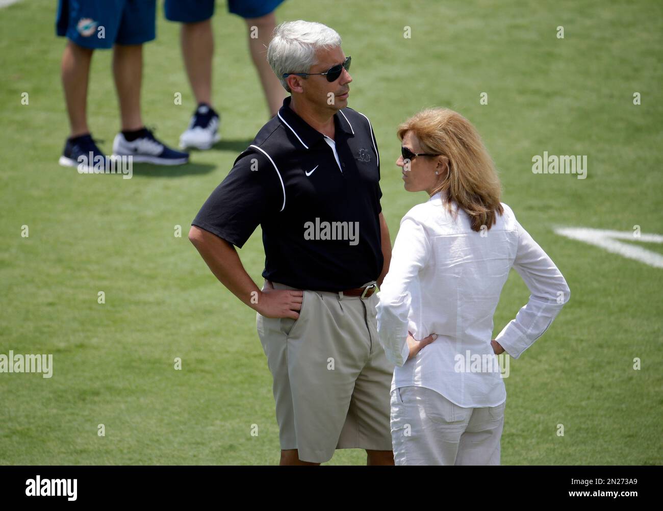 Miami Dolphins general manager Dennis Hickey, left, watches players do ...