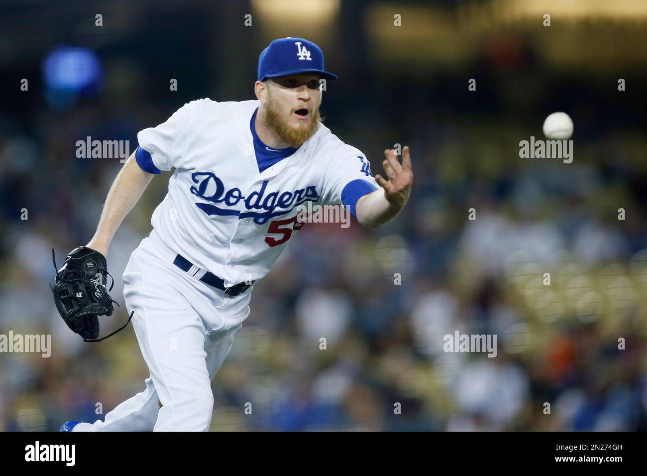 Los Angeles Dodgers relief pitcher J.P. Howell tosses the ball to first ...