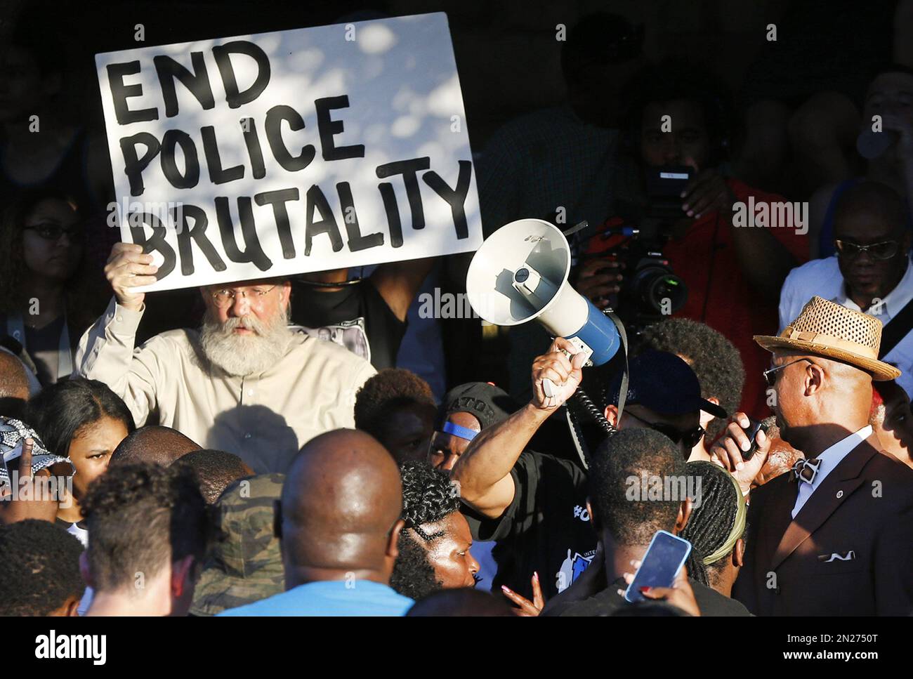 Demonstrators gather near a community pool during a protest Monday ...