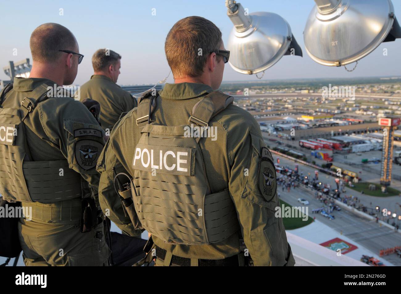 Fort Worth SWAT officers watch from atop the roof of the building ...