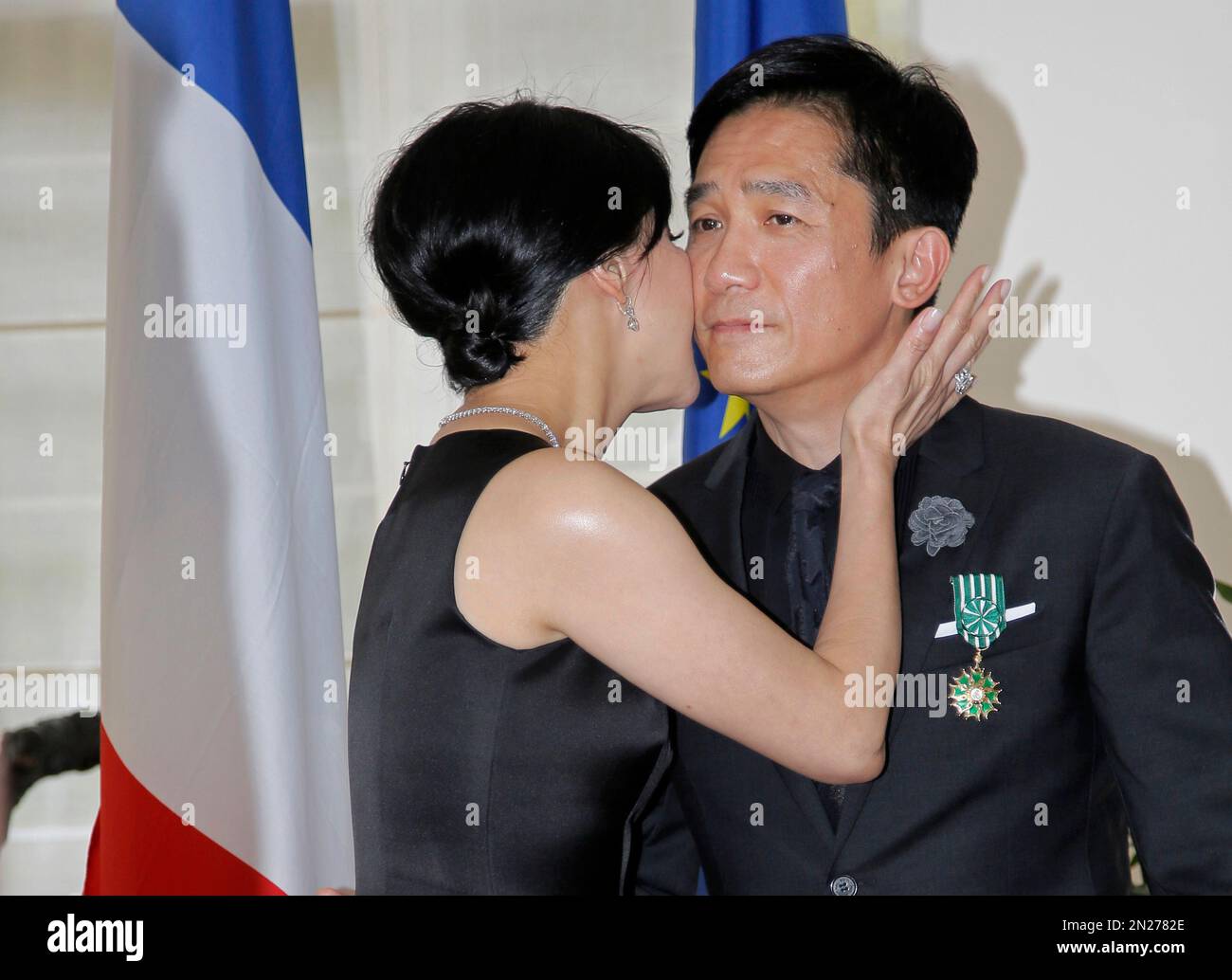 Hong Kong actor Tony Leung is kissed by actress Carina Lau after ...