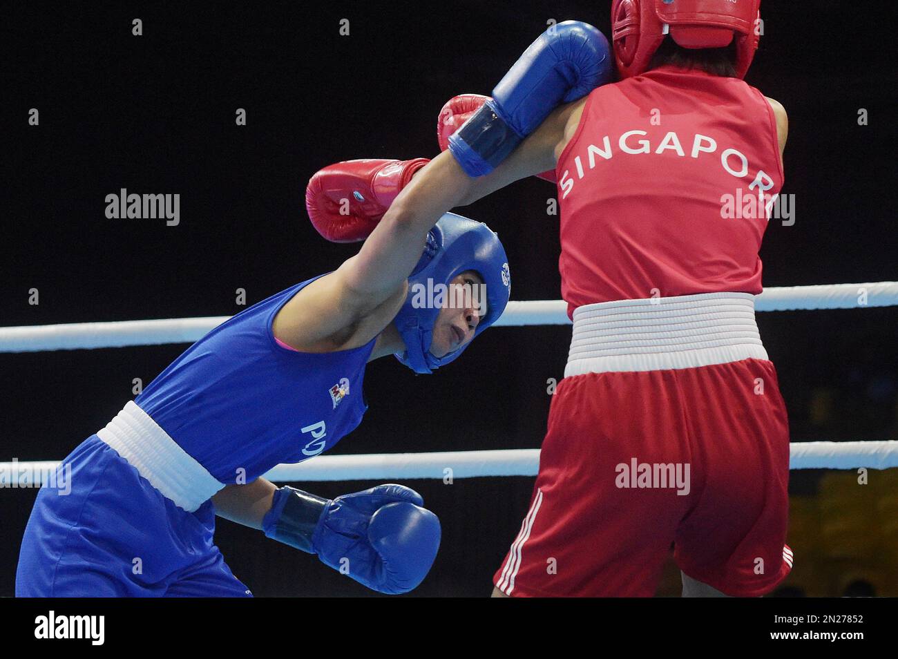 Philippines' Josie Gabuco, left, throws a punch at Singapore's Leona ...