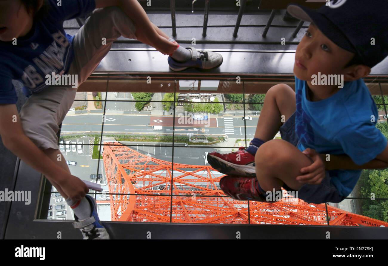 Boys sit on the "look down window" on the 150-meter (492-foot)-high ...