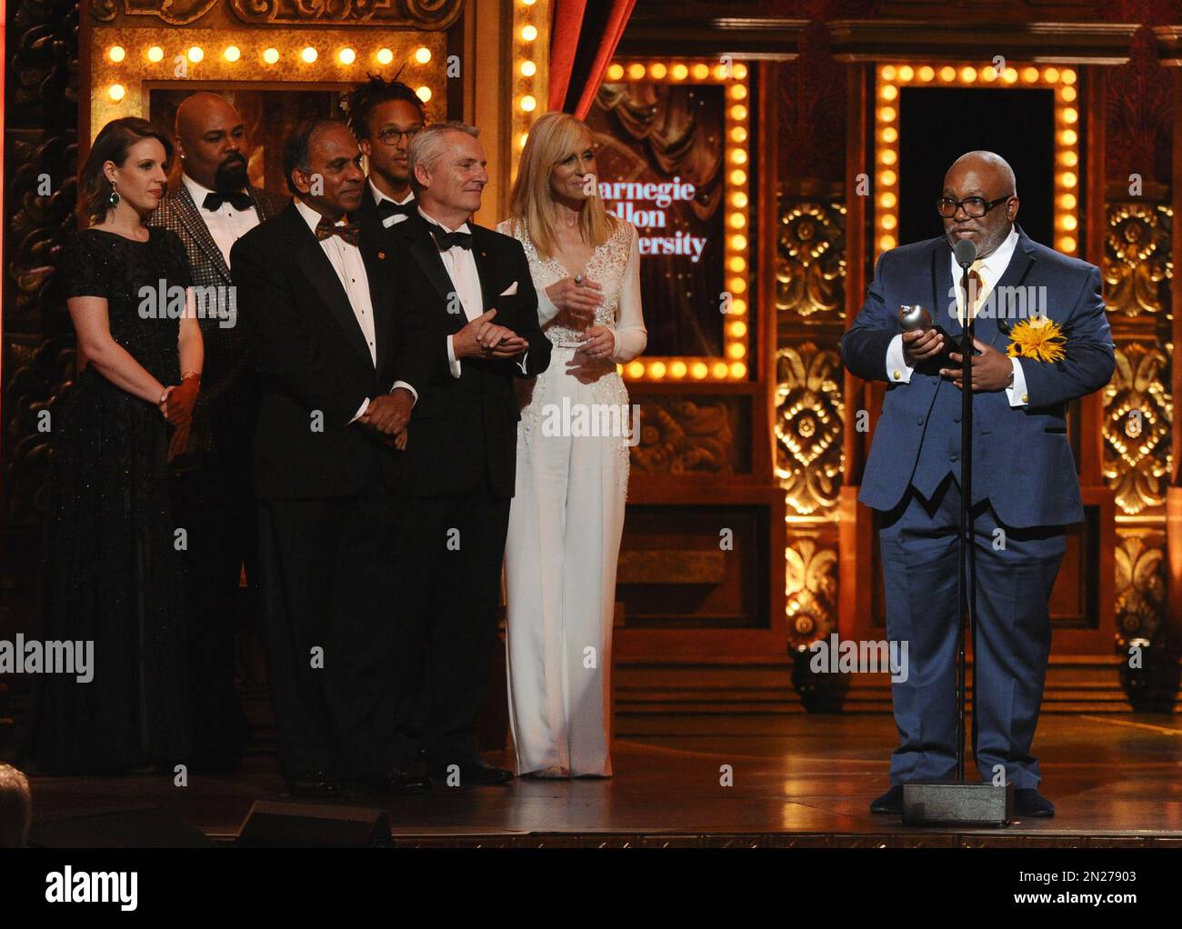 Corey Mitchell, right, accepts the award for excellence in theatre ...
