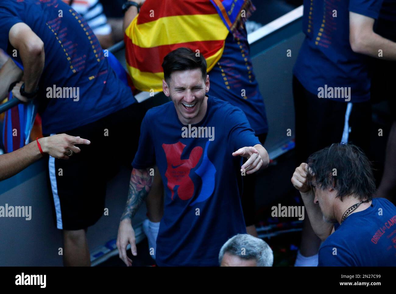 Barcelona's Lionel Messi celebrates with team mates as they ride on a ...
