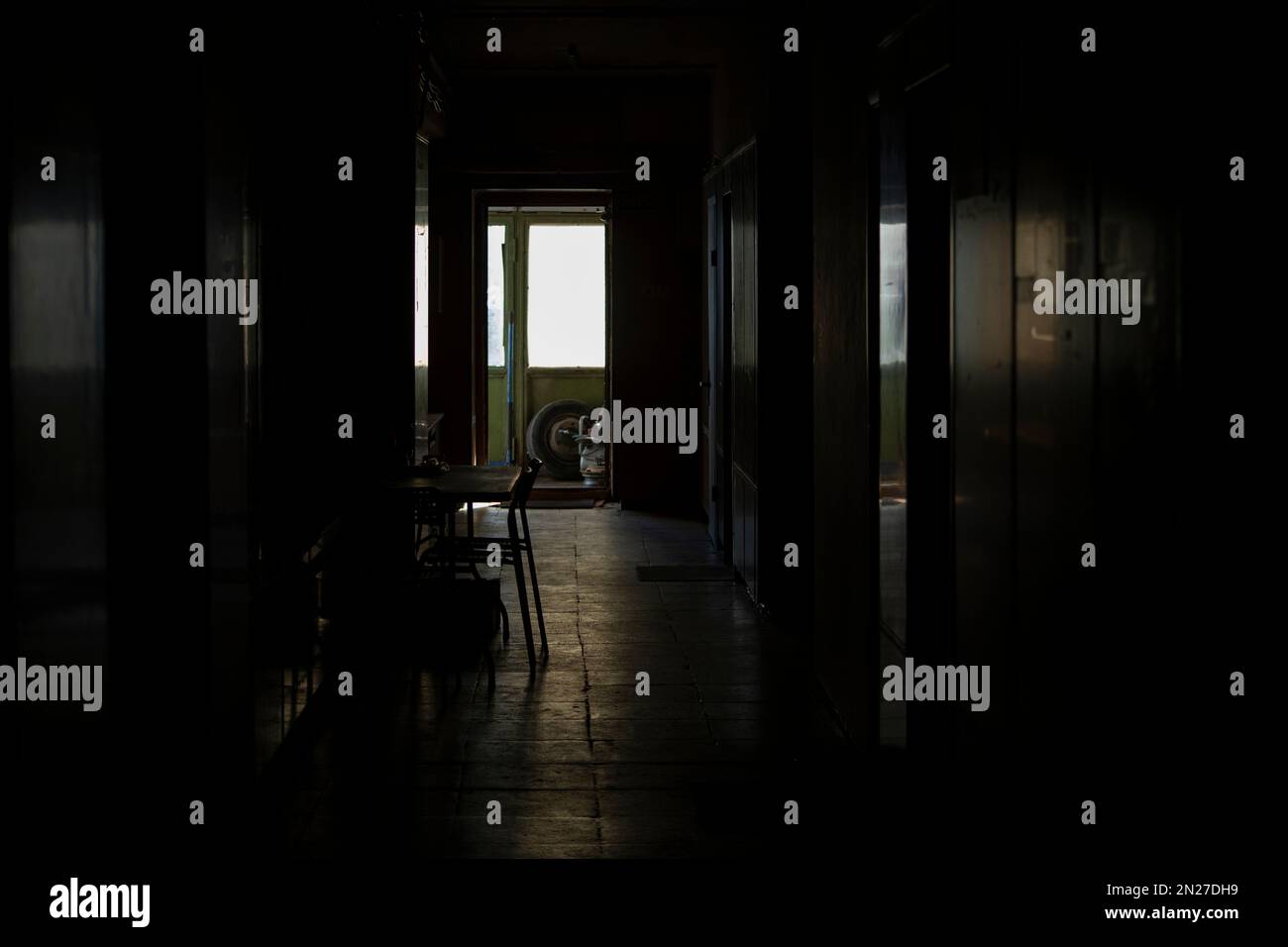 Interior light from window. Dark corridor and light at end. Reflection ...